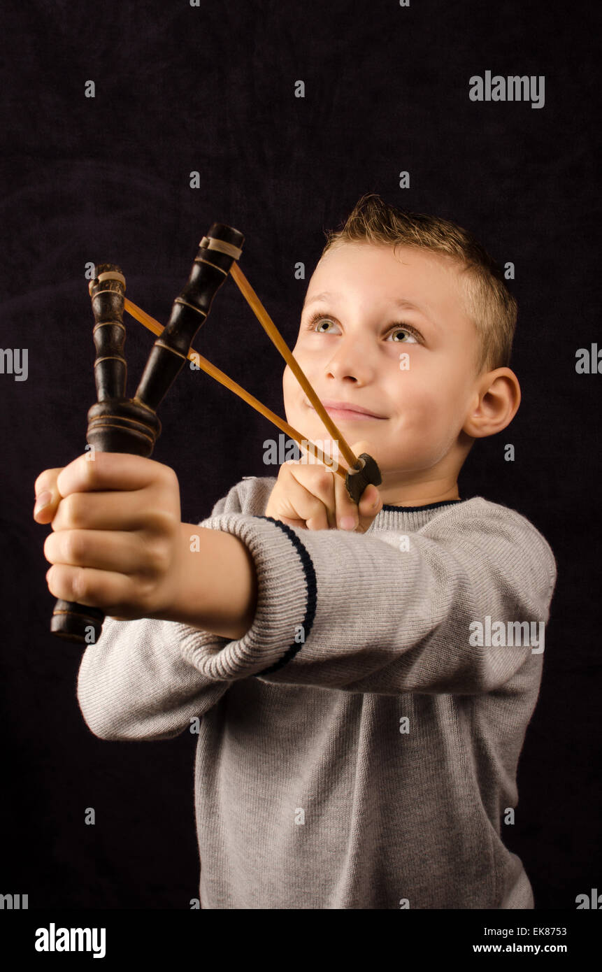 Boy aiming with slingshot hi-res stock photography and images - Alamy