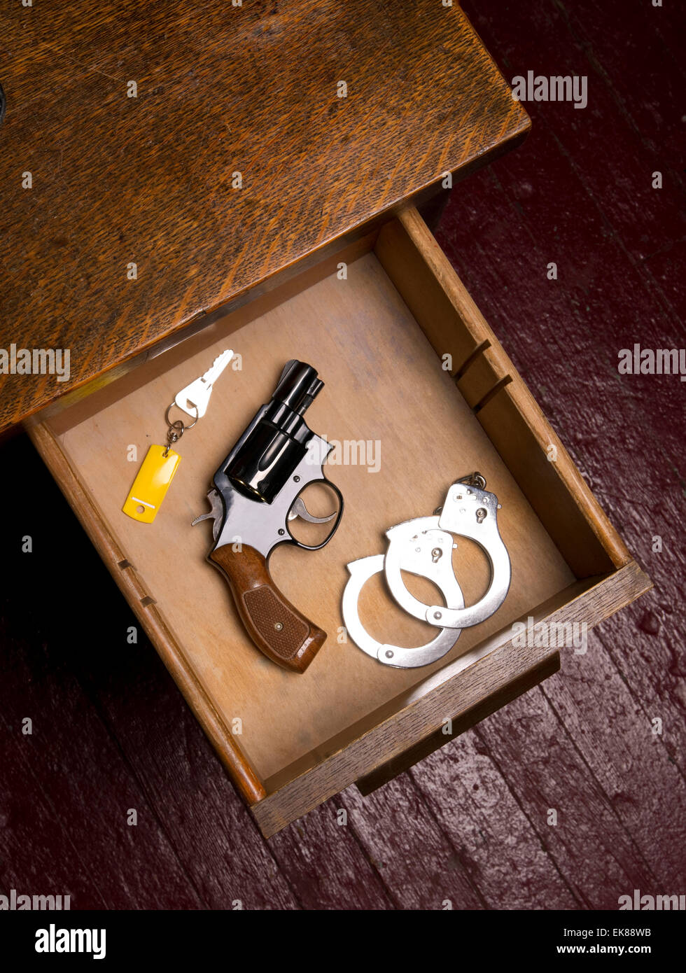 38 Revolver in Desk Drawer with Handcuffs Stock Photo - Alamy