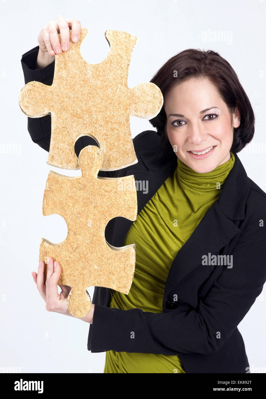 Woman Working With Two Large Jigsaw Puzzle Pieces Stock Photo - Alamy