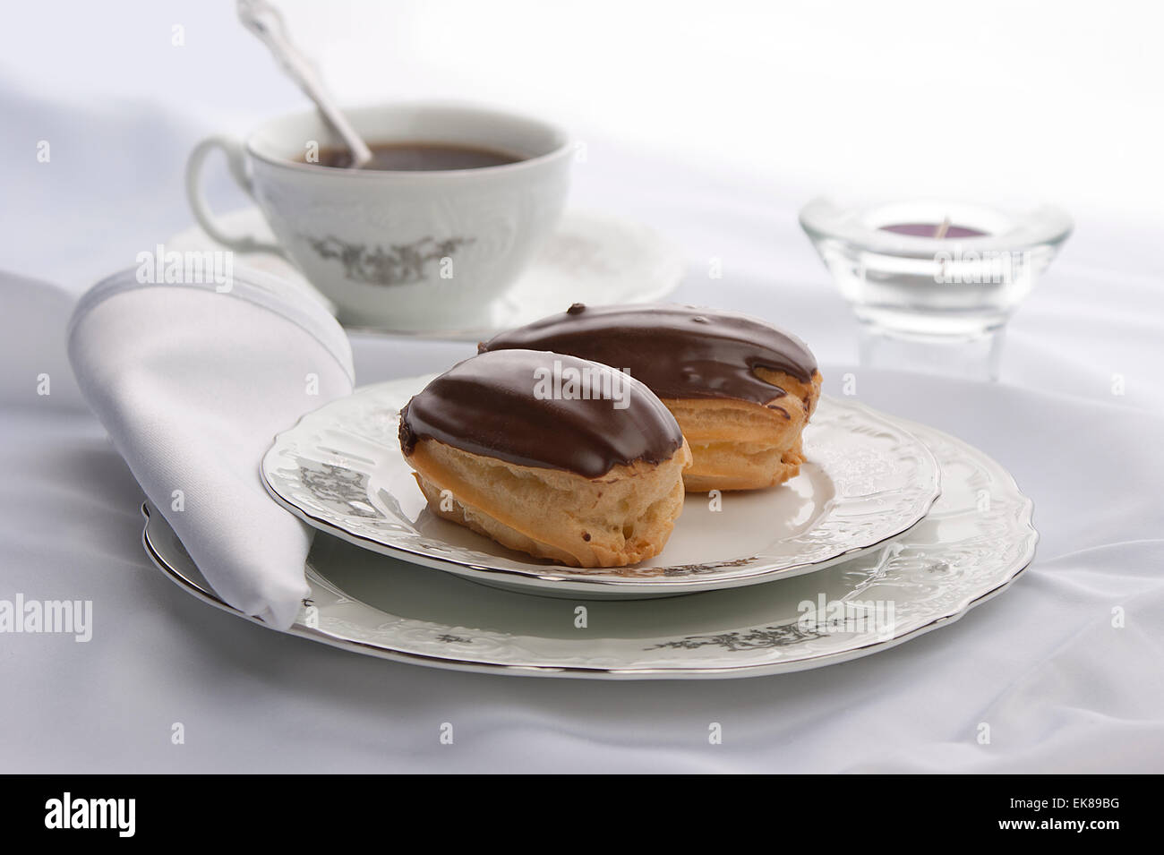 Eclairs with tea Stock Photo - Alamy
