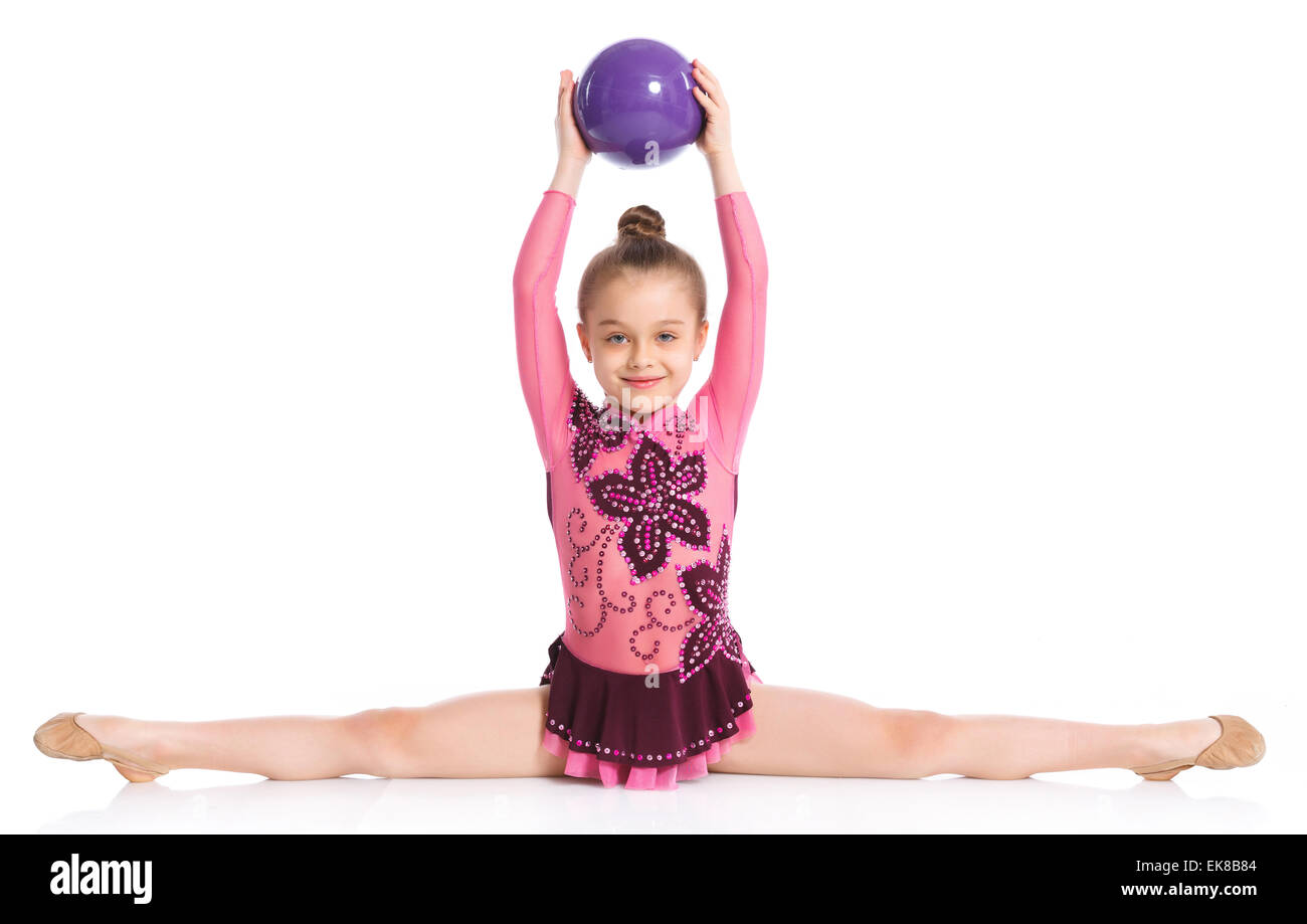 Young cute girl doing gymnastics with ball over white background Stock ...