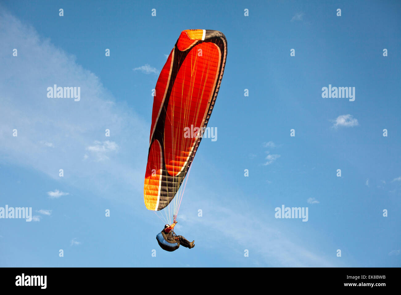 Man with red para glider against a blue sky Stock Photo - Alamy