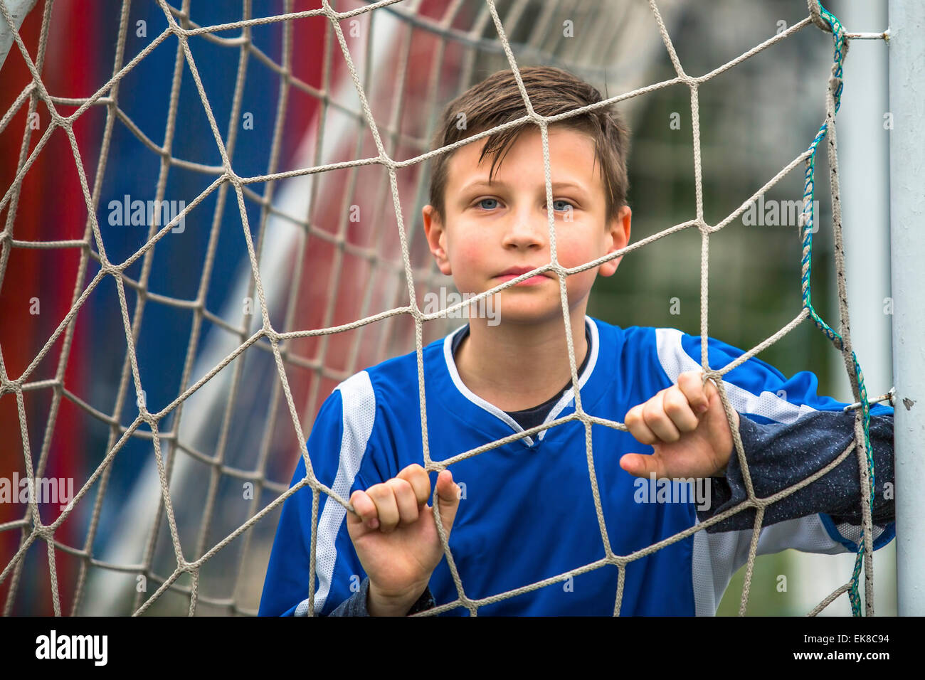 Boy playing football at the stadium, close-up portrait Stock Photo - Alamy