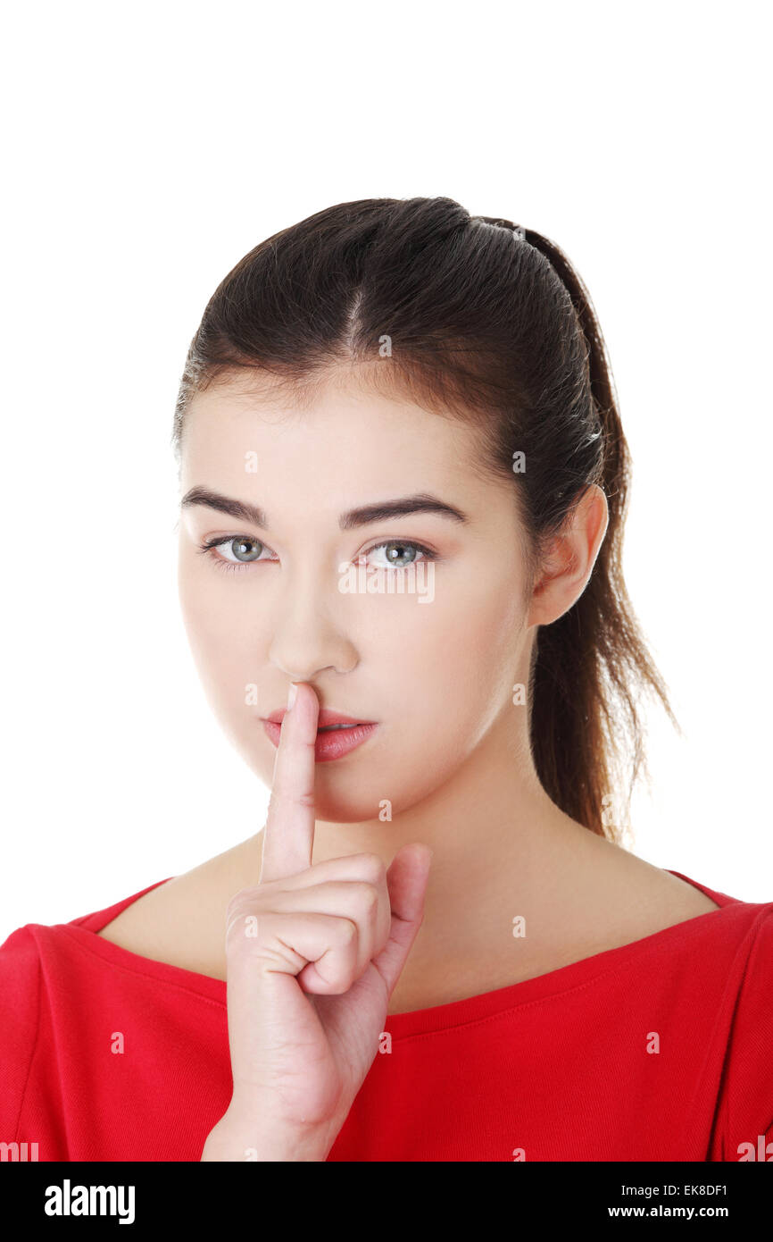 Woman making a keep it quiet gesture Stock Photo - Alamy