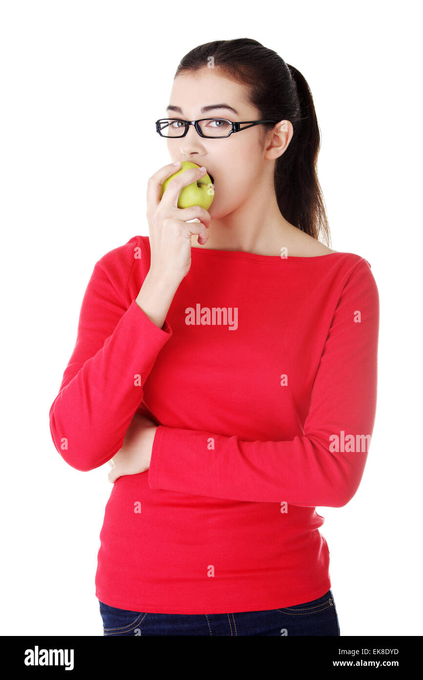Attractive young woman eating green apple Stock Photo - Alamy