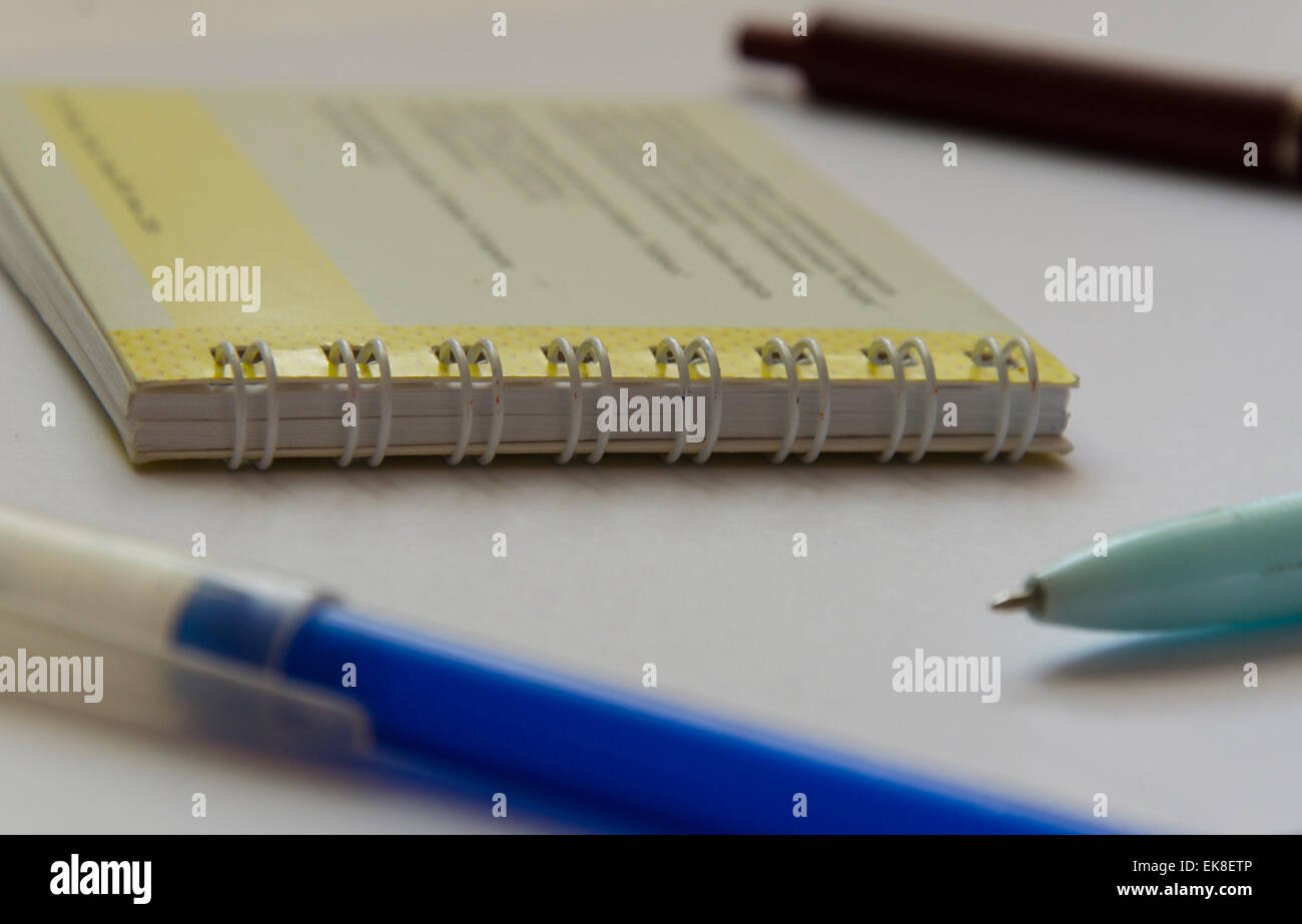 Pens and note Stock Photo - Alamy