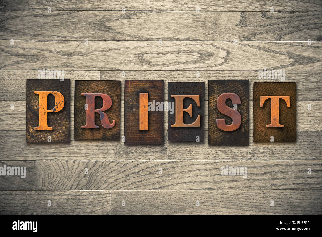 The word "PRIEST" theme written in vintage, ink stained, wooden ...