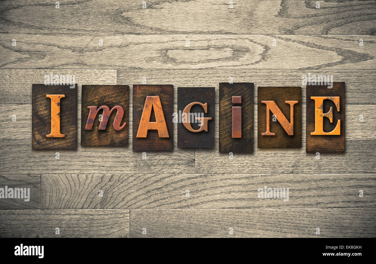The word "IMAGINE" theme written in vintage, ink stained, wooden ...