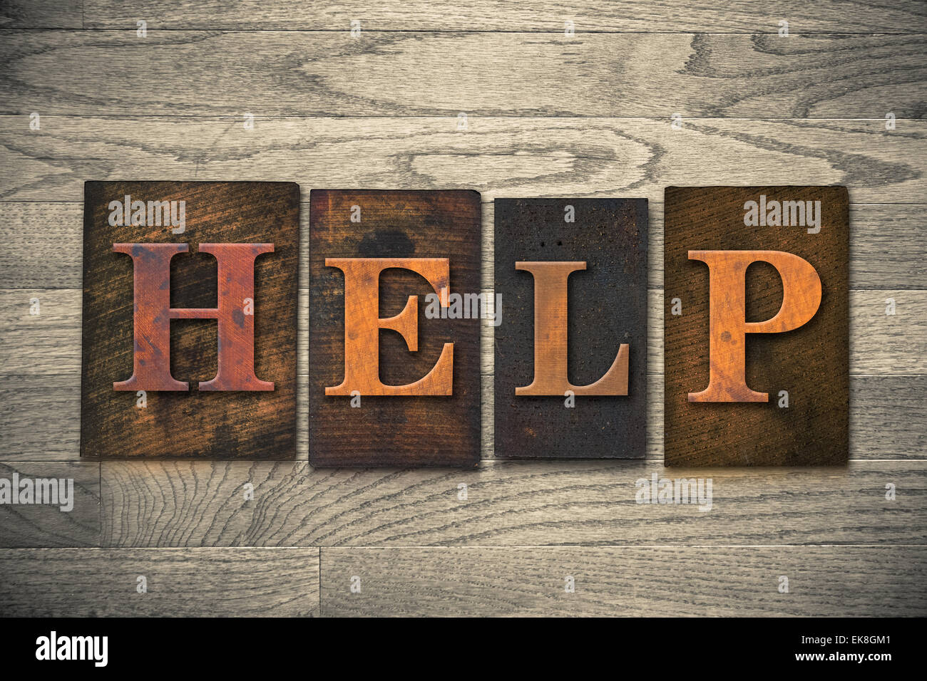 The word "HELP" theme written in vintage, ink stained, wooden ...
