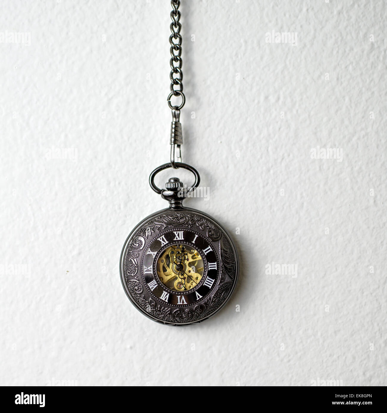 Old pocket watch hanging on the white wall Stock Photo - Alamy