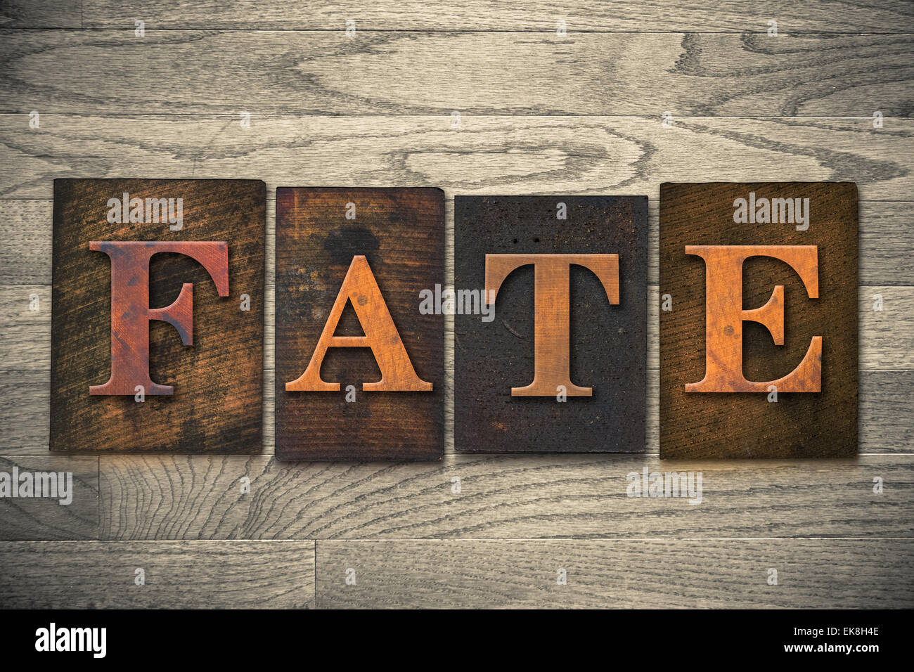 The word "FATE" theme written in vintage, ink stained, wooden ...