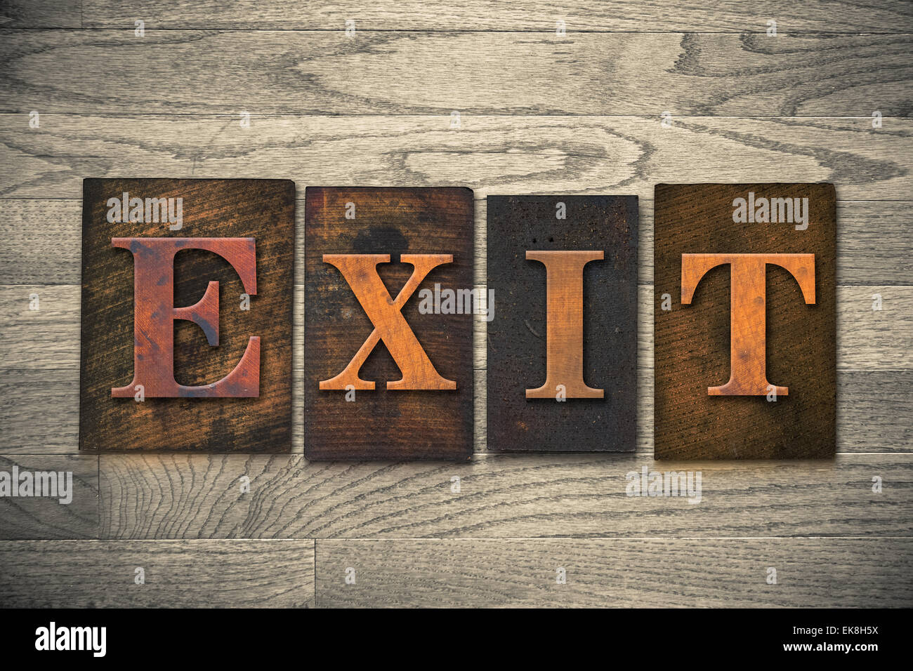 The word "EXIT" theme written in vintage, ink stained, wooden ...