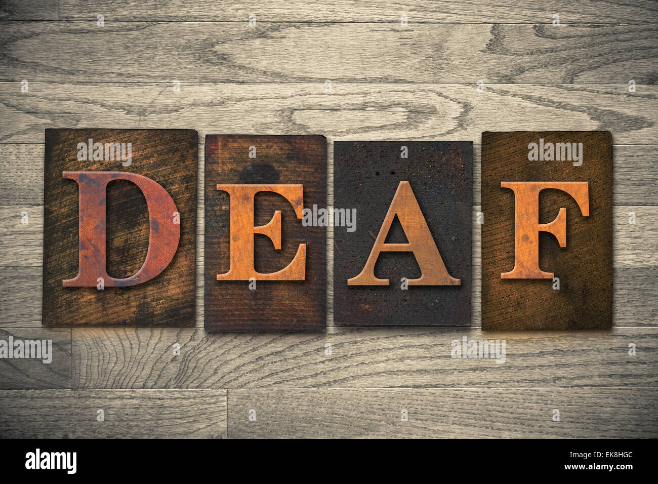 The word "DEAF" theme written in vintage, ink stained, wooden ...