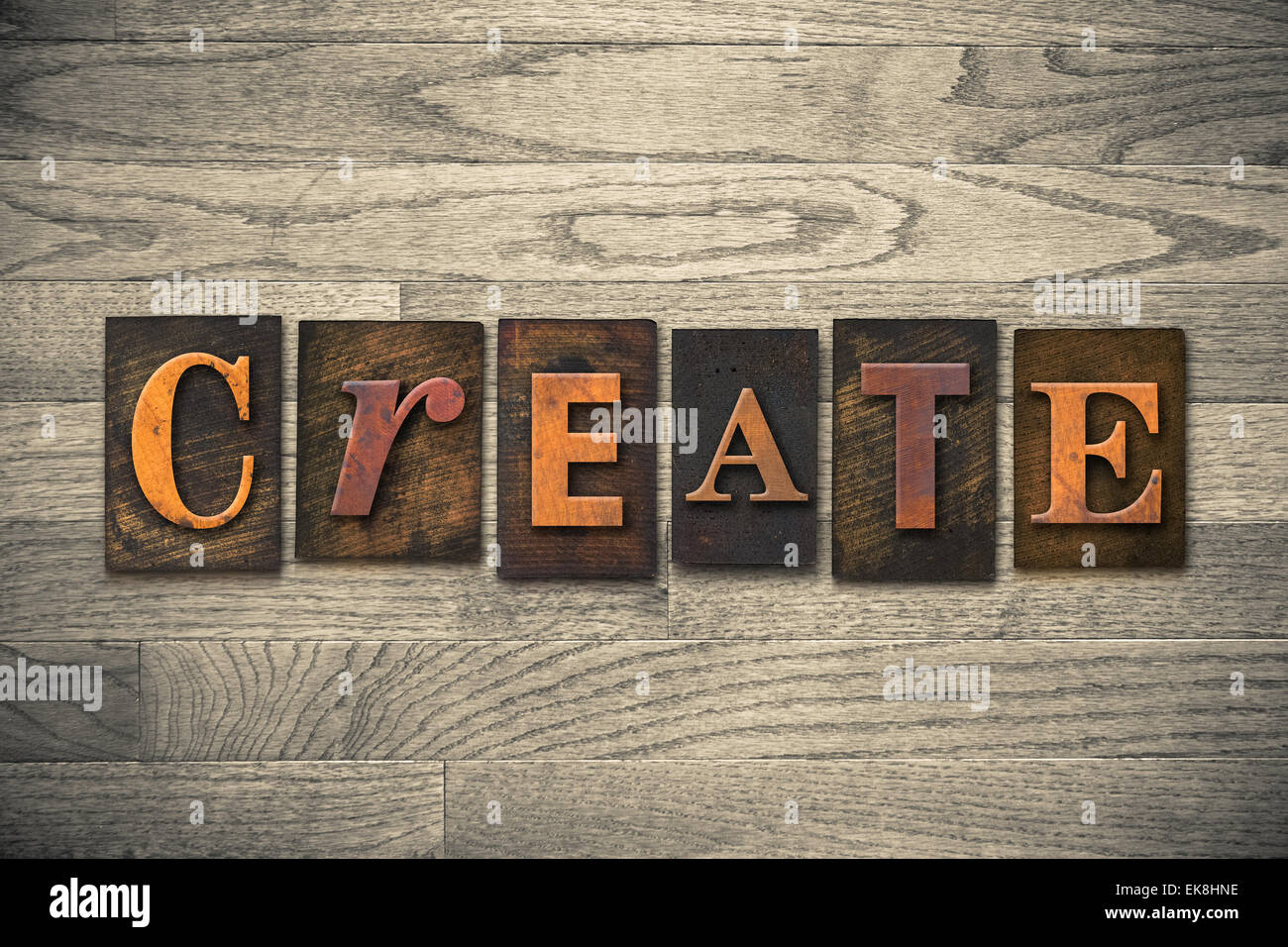 The word "CREATE" theme written in vintage, ink stained, wooden ...