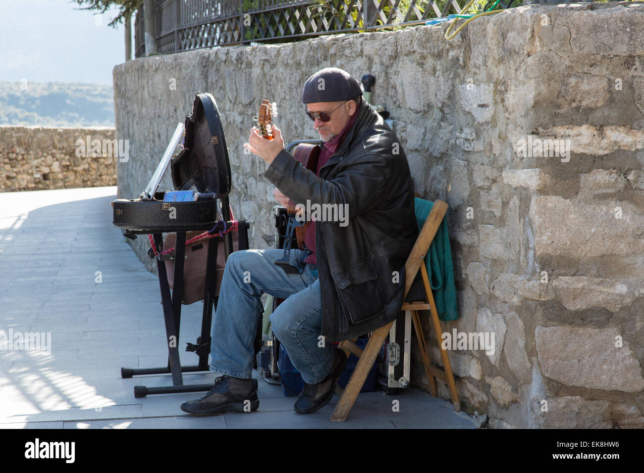A male busker playing at the Puente Nuevo bridge in Ronda Spain Stock ...