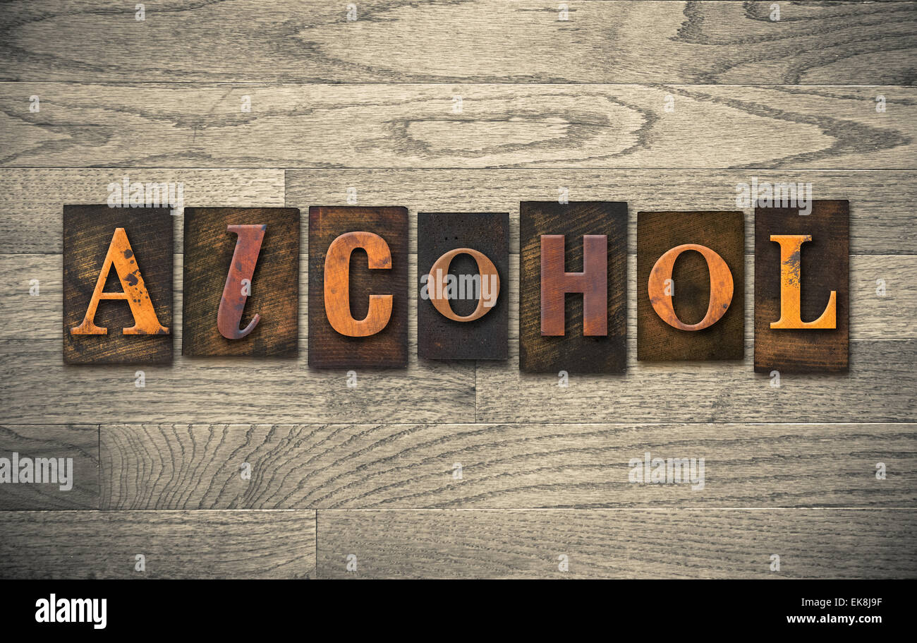The word "ALCOHOL" theme written in vintage, ink stained, wooden ...