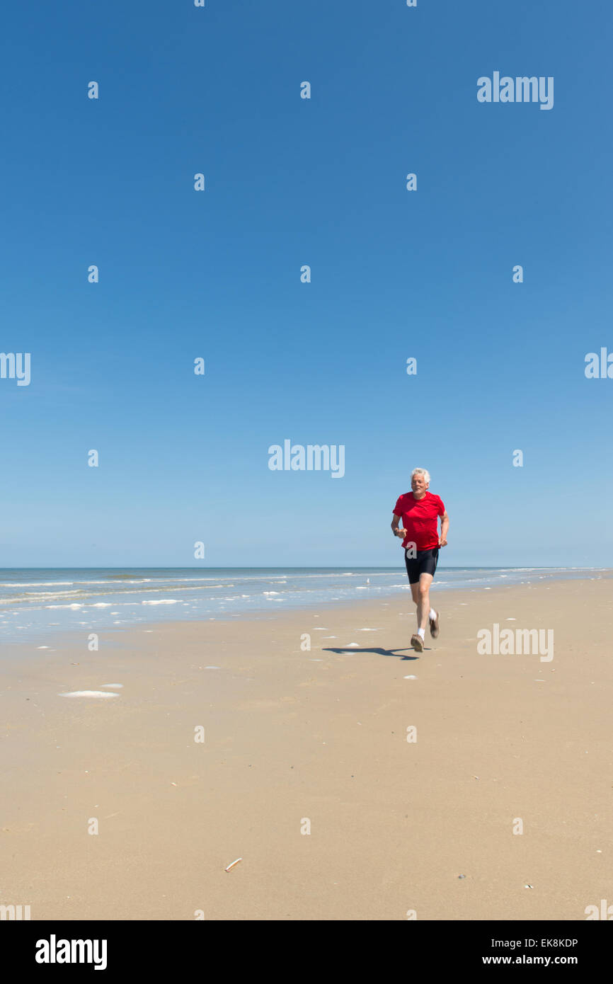 Elder man running beach hi-res stock photography and images - Alamy