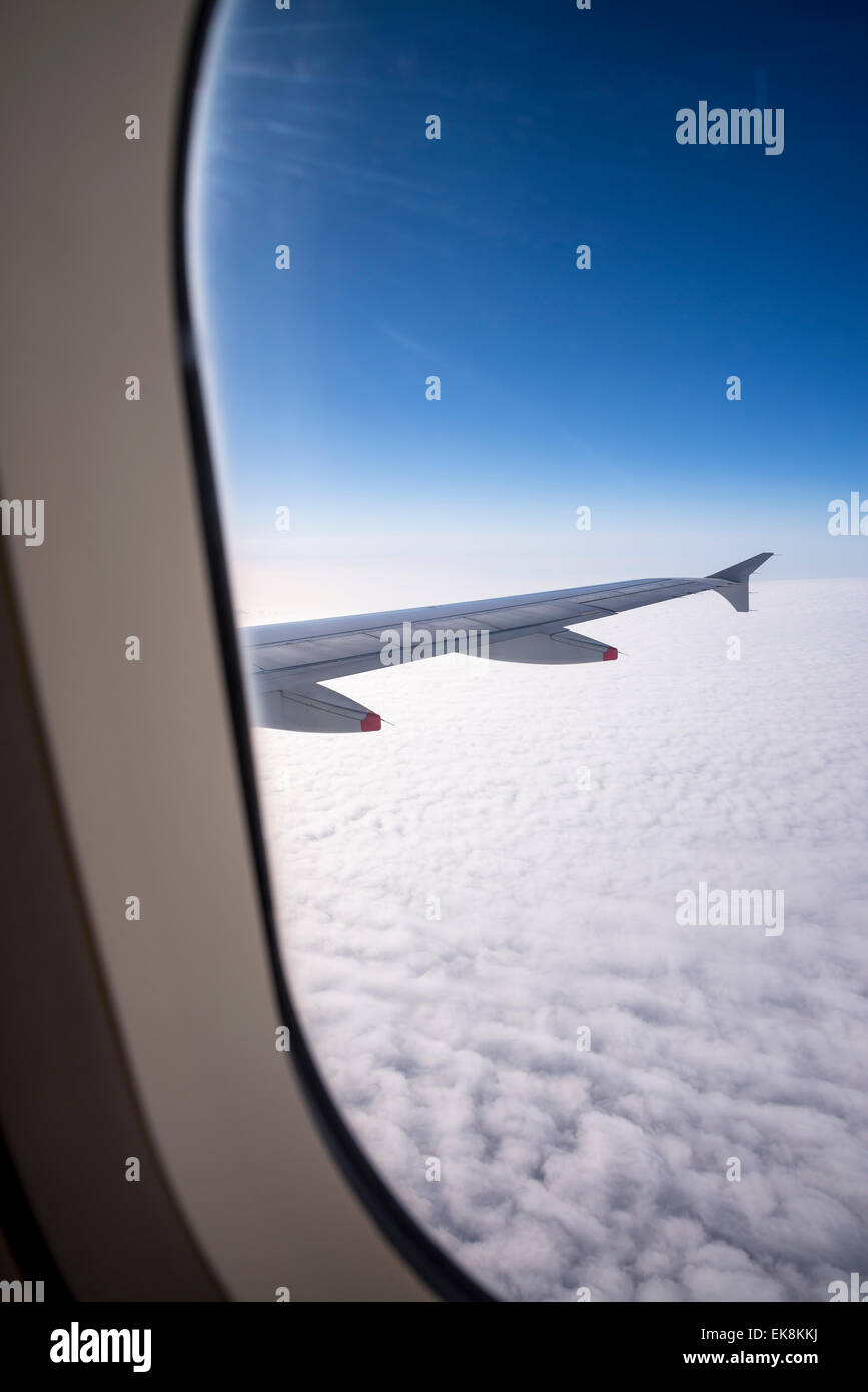 Airplane wing seen through plane window Stock Photo - Alamy
