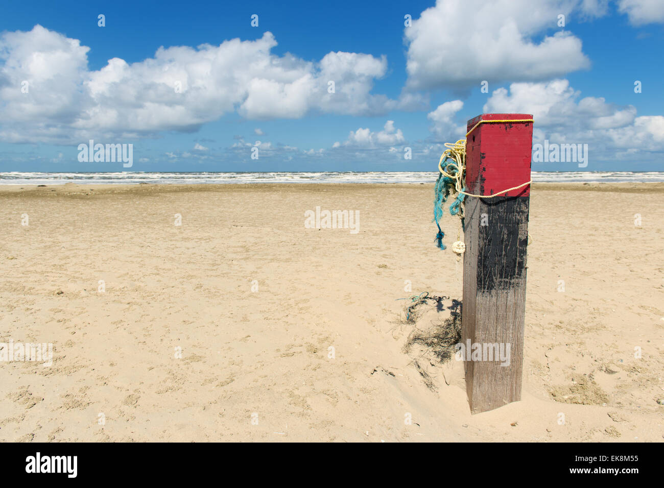Wooden pole at the beach of Dutch wadden island Terschelling Stock ...