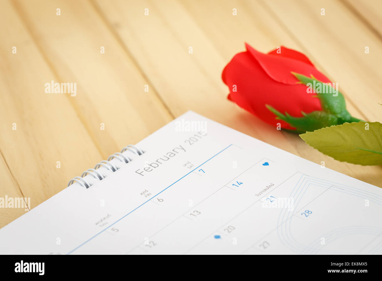 Close up Rose and calendar on wooden floor Stock Photo - Alamy