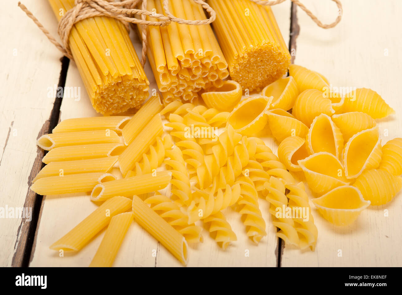 bunch of Italian pasta type on a white rustic table Stock Photo - Alamy