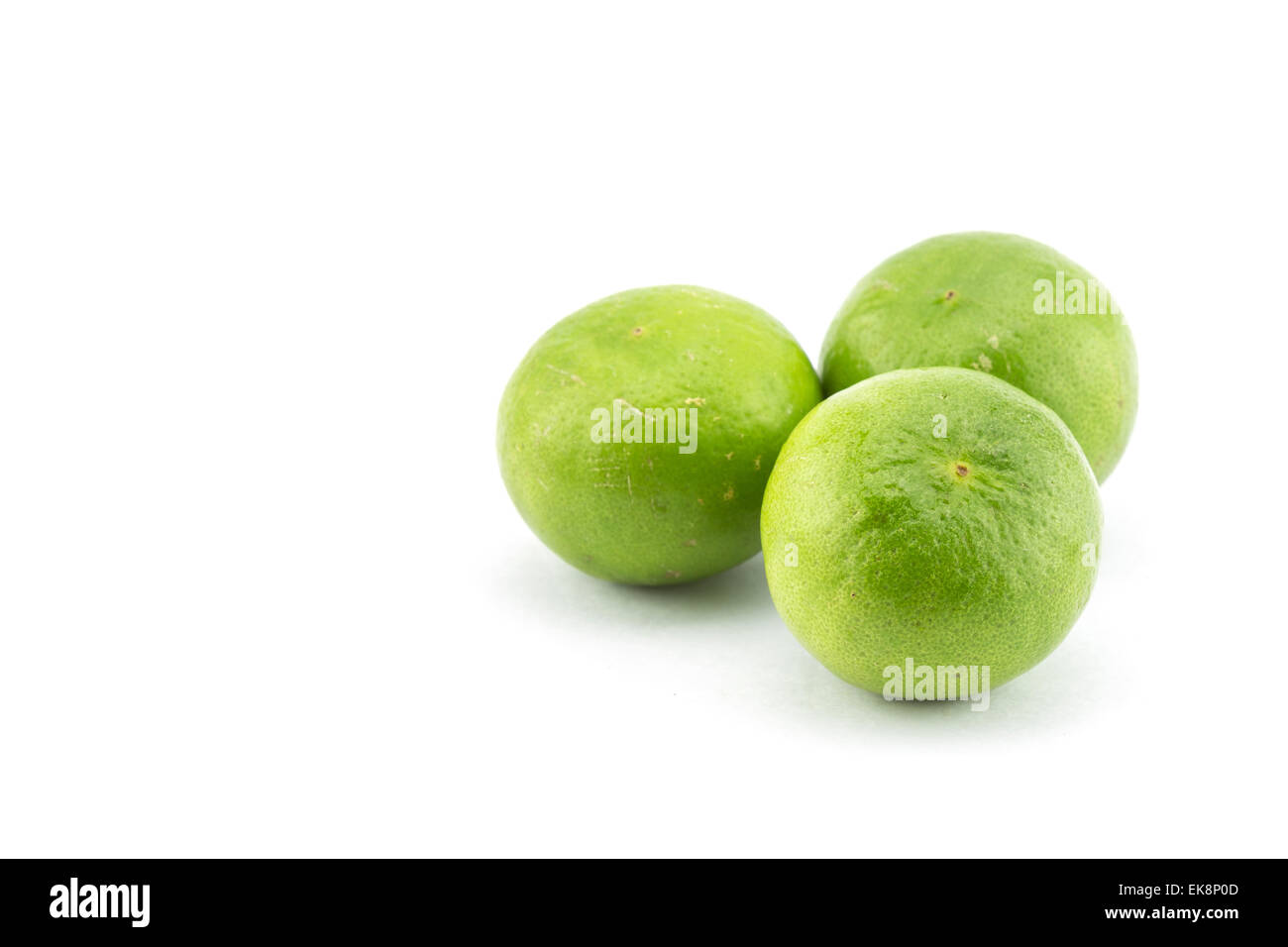 Green lemons isolated on white background Stock Photo - Alamy