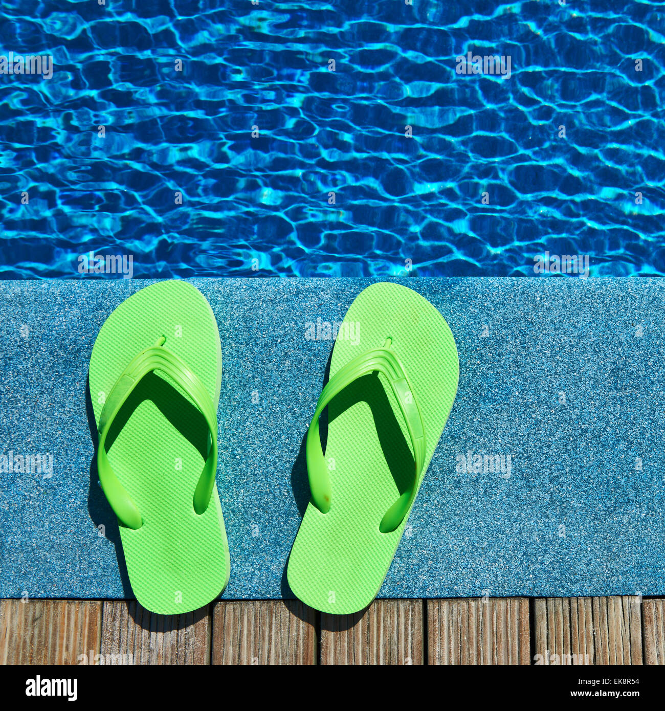 Sandals by a swimming pool Stock Photo - Alamy