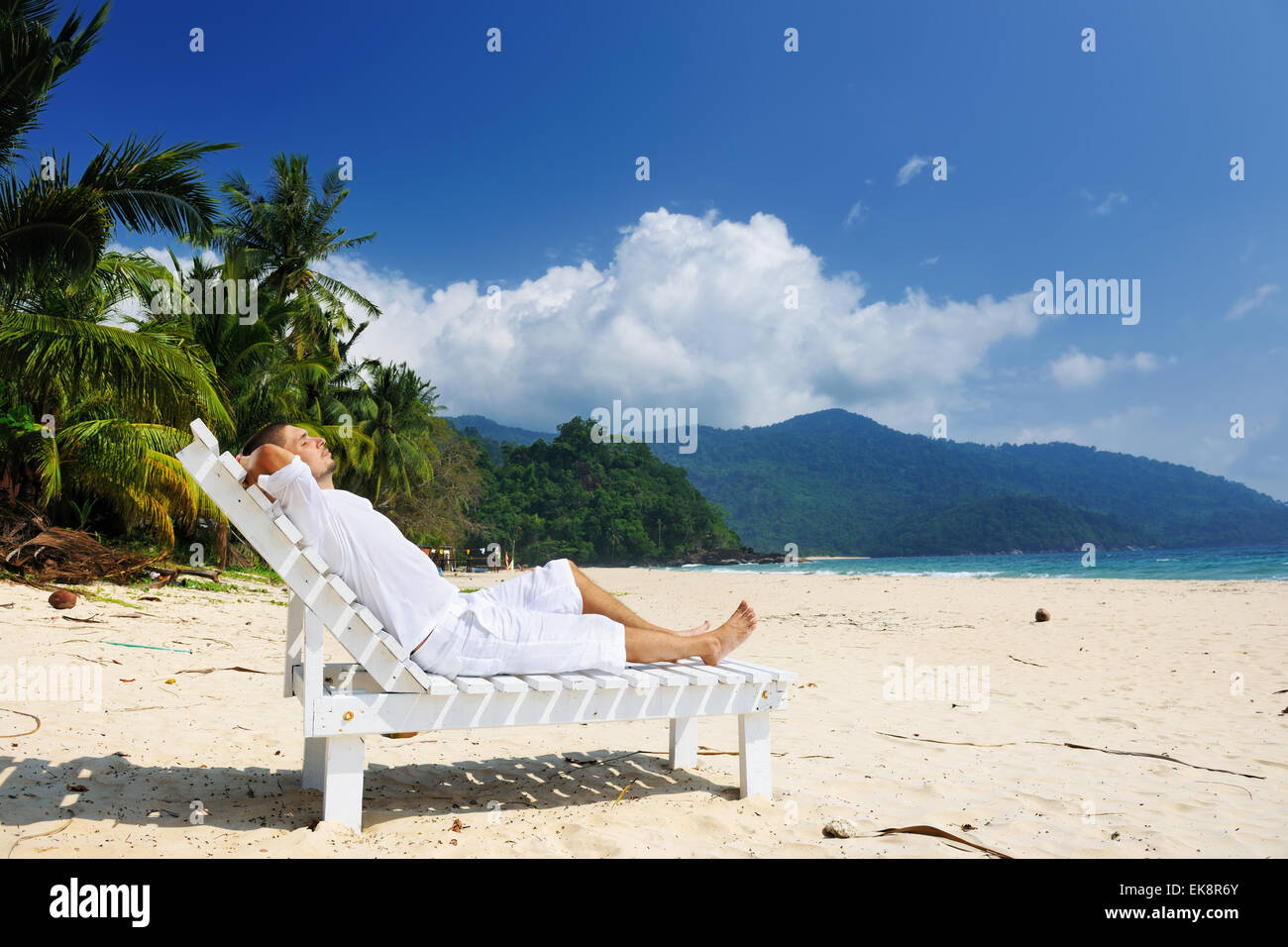 Man relaxing on a beach Stock Photo - Alamy