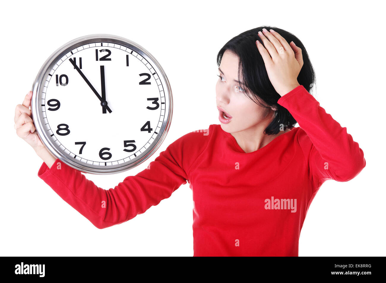 Shocked woman holding office clock Stock Photo - Alamy