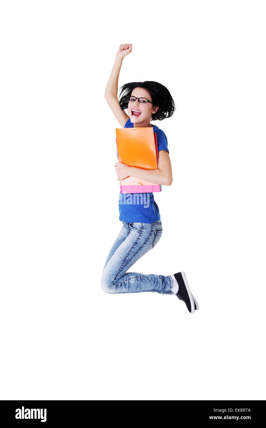 Happy female student jumping with a notebook Stock Photo - Alamy