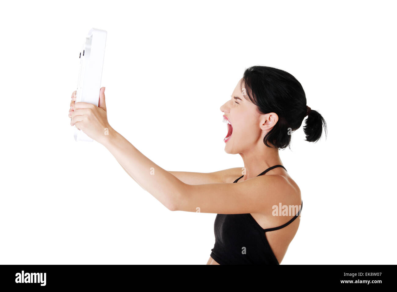 Frustrated woman with scale Stock Photo - Alamy