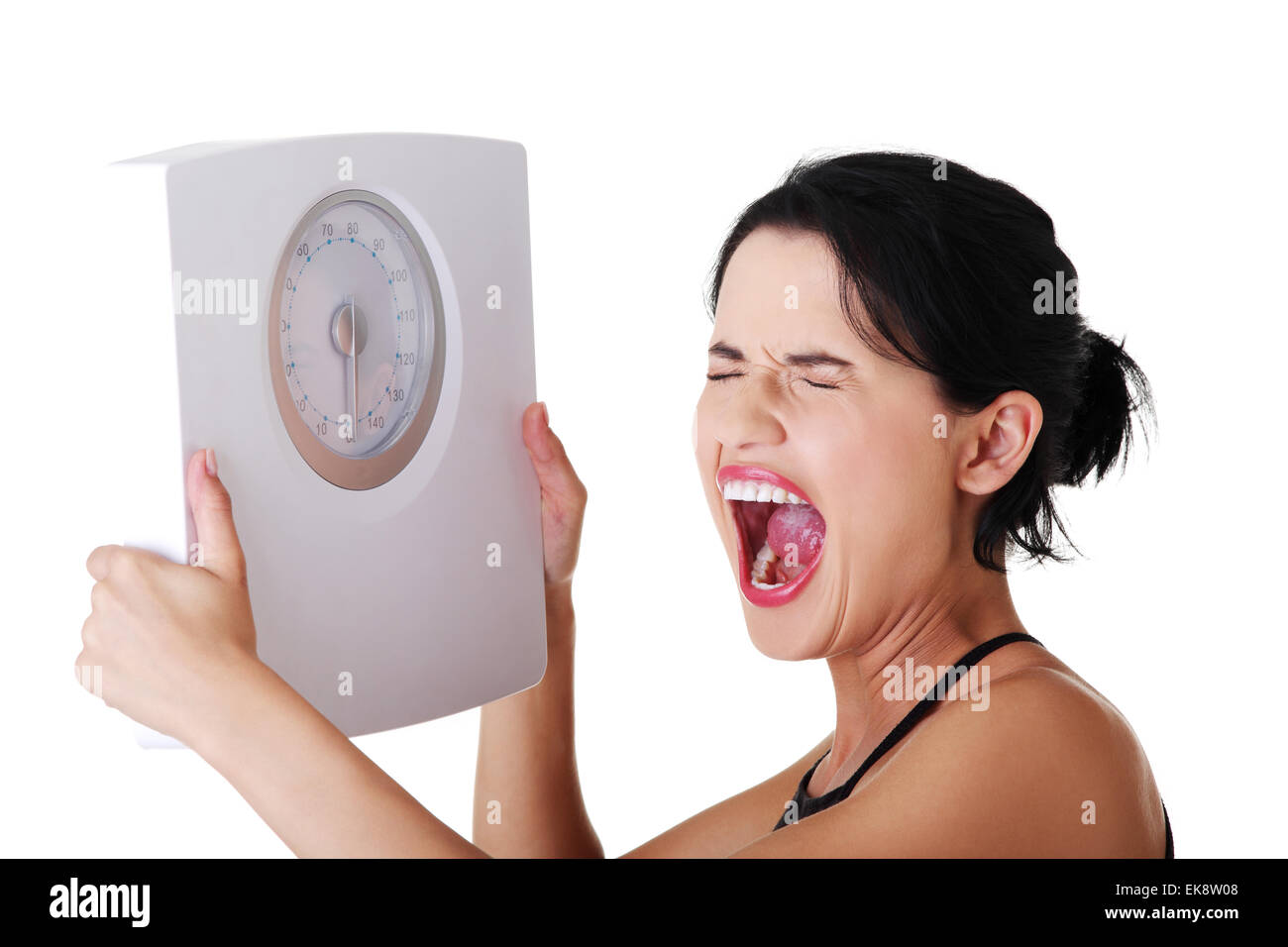 Frustrated woman with scale Stock Photo - Alamy