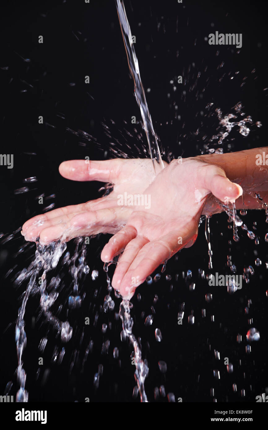 Water falling on female hands Stock Photo - Alamy