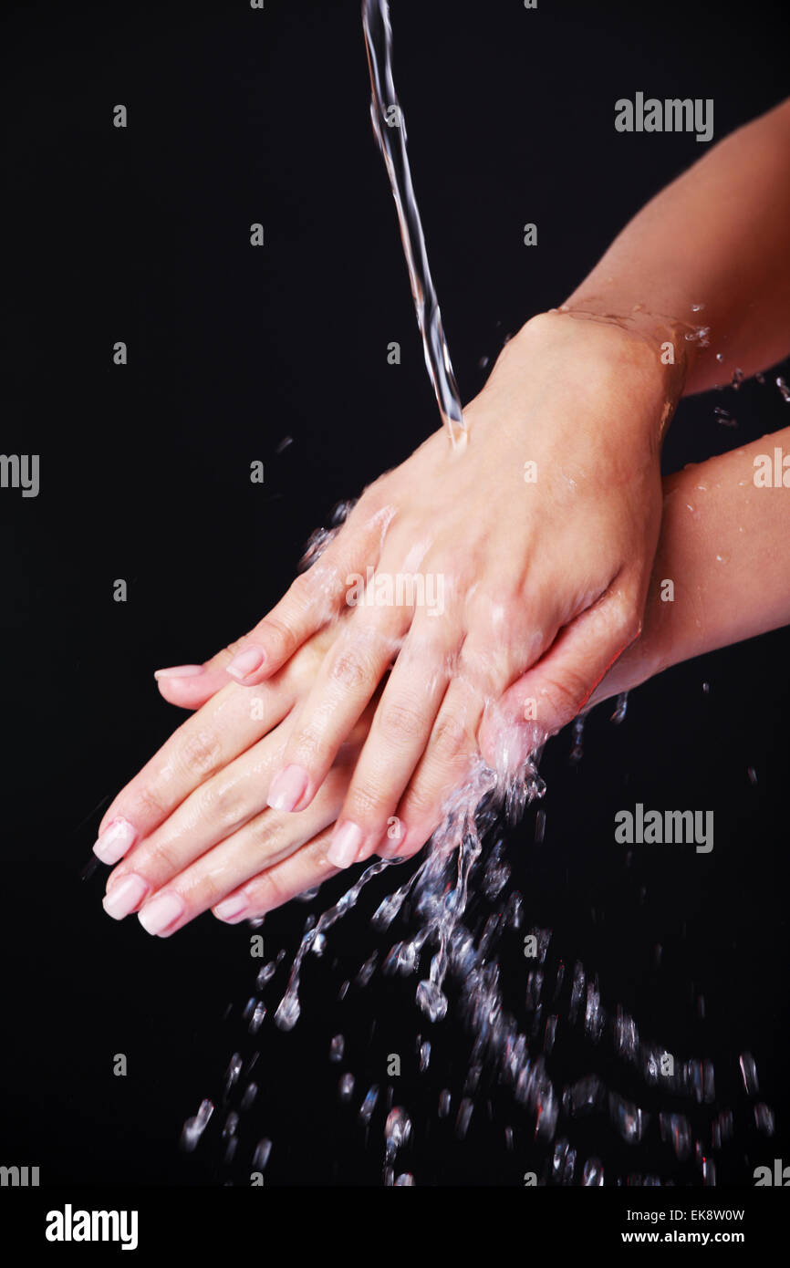 Water falling on female hands Stock Photo - Alamy