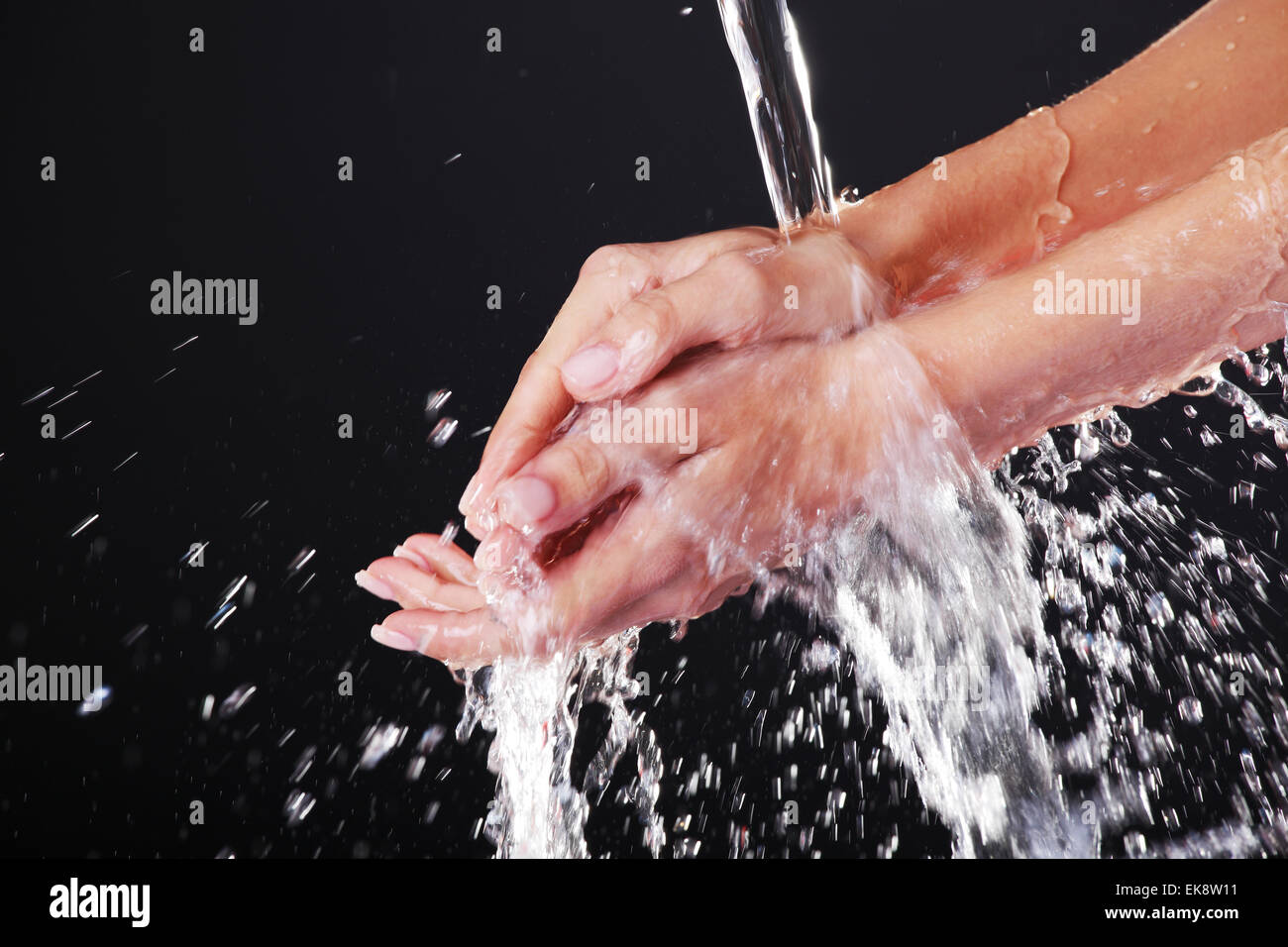 Water falling on female hands Stock Photo - Alamy