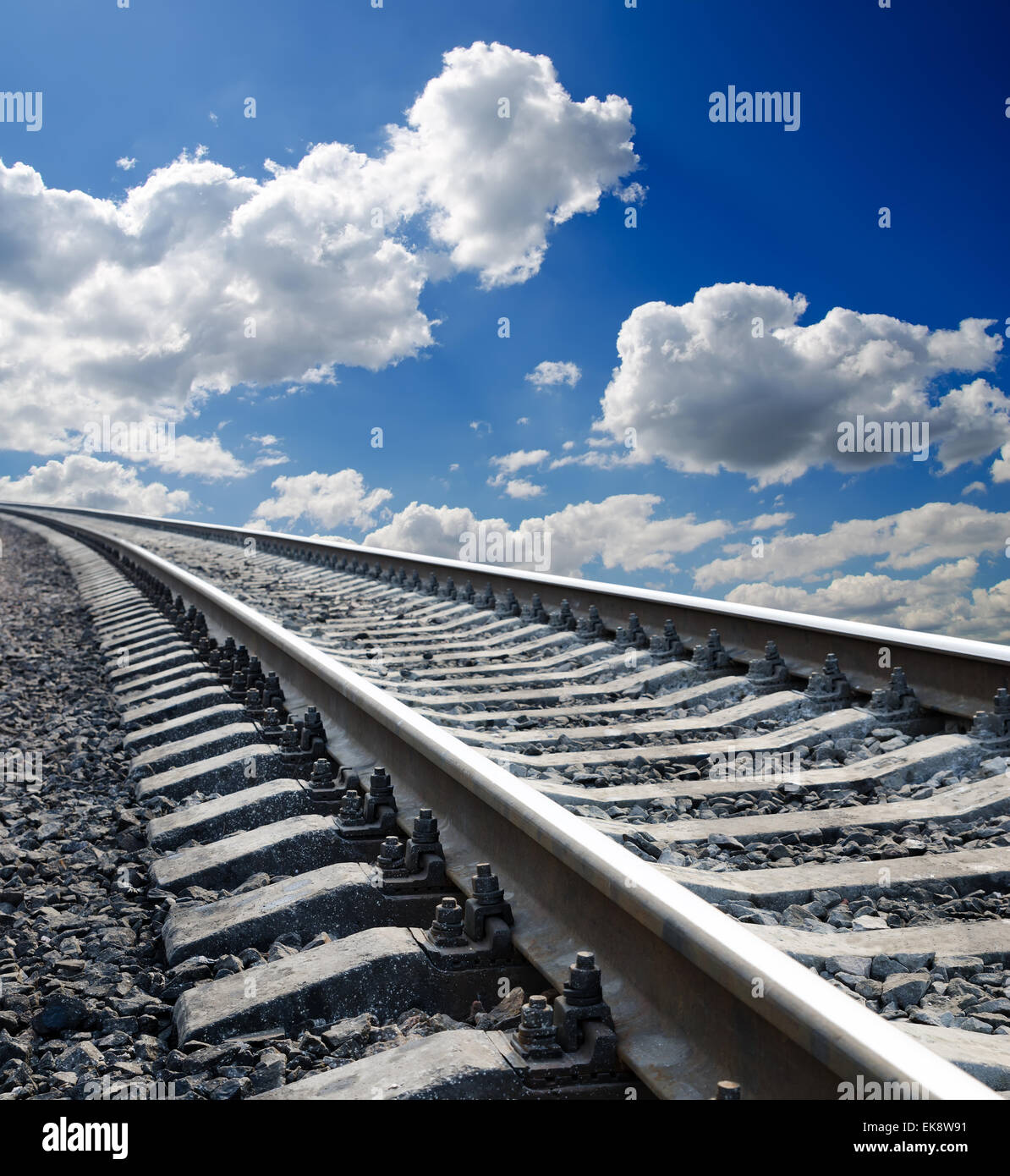 low view to railroad under deep blue cloudy sky Stock Photo - Alamy