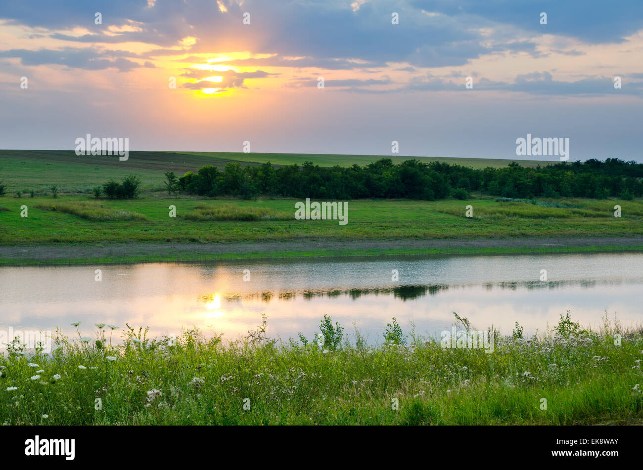 sunset over river Stock Photo - Alamy