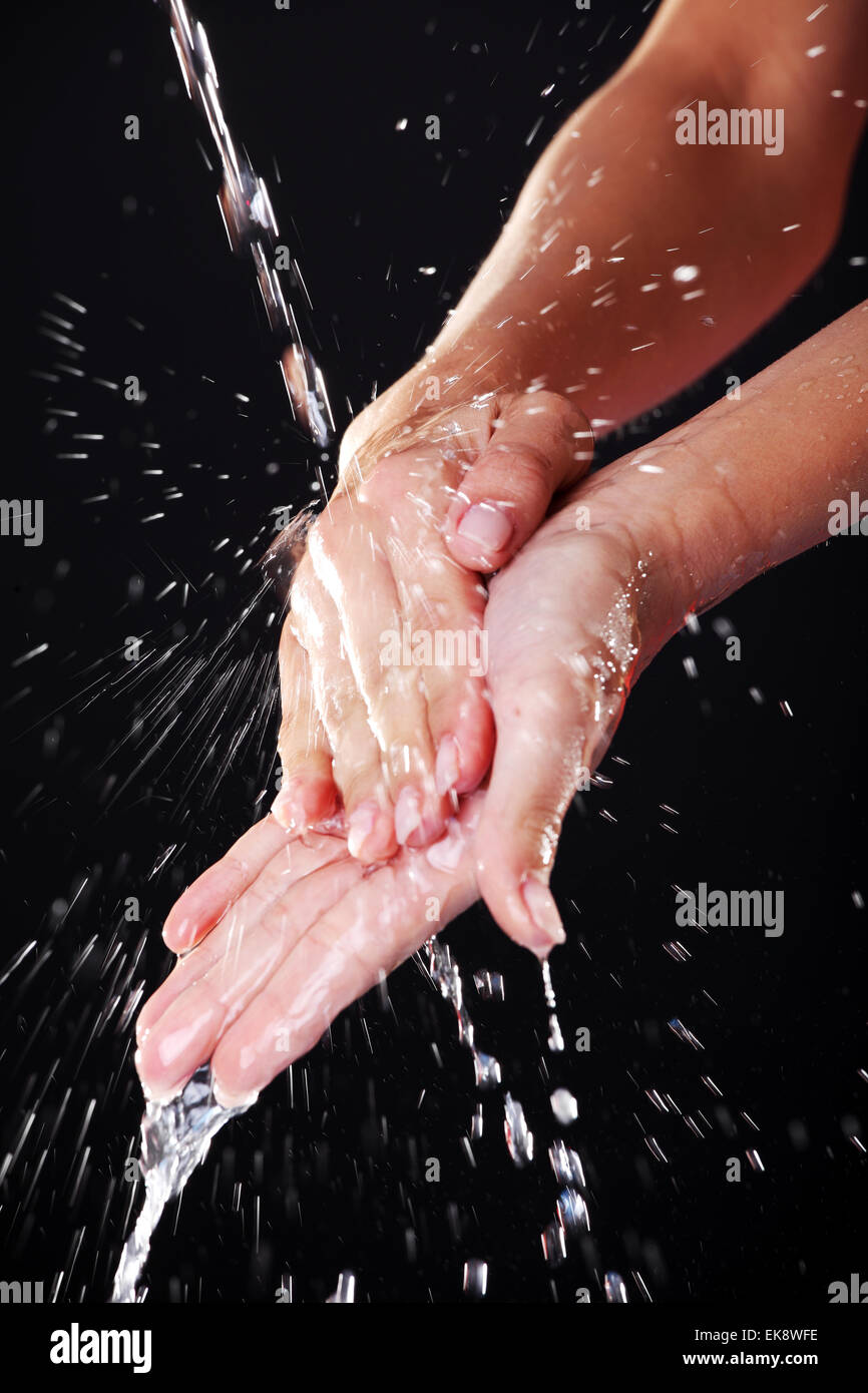 Water falling over hand hi-res stock photography and images - Alamy