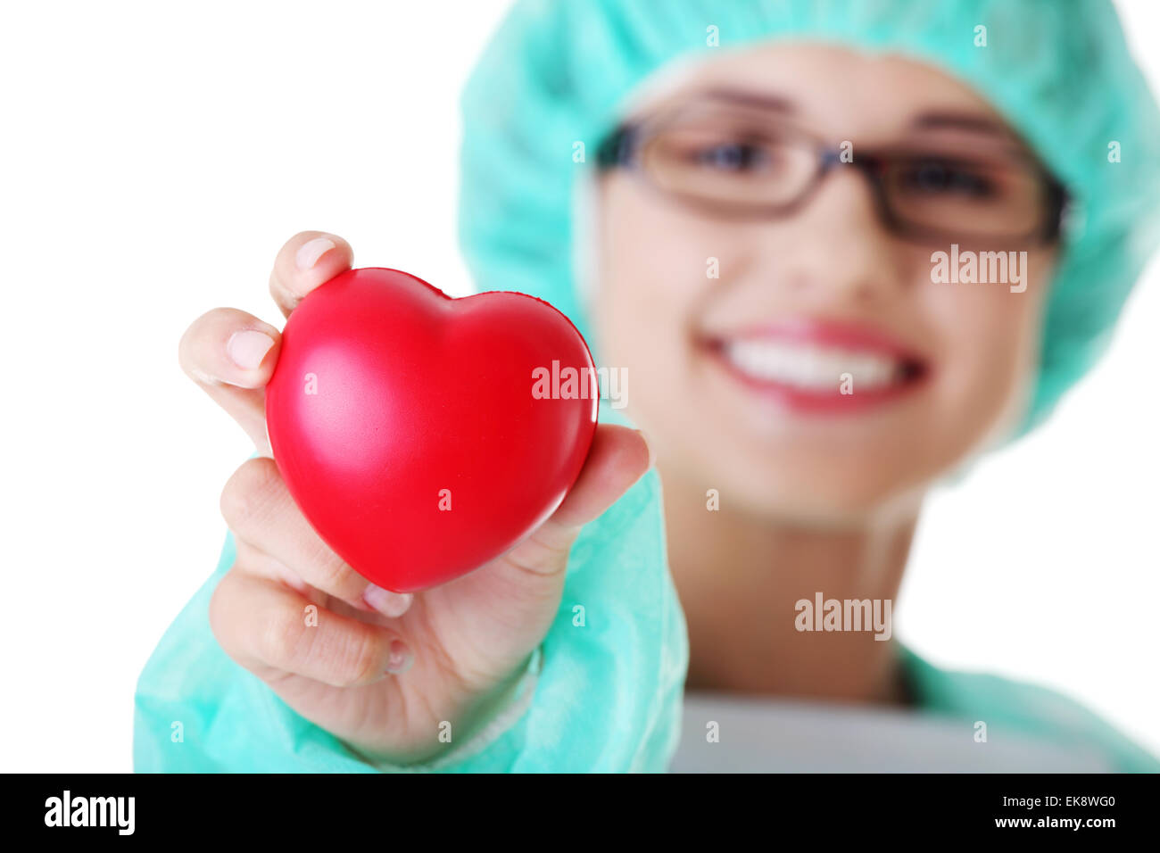 Smiling female doctor or nurse holding heart Stock Photo - Alamy