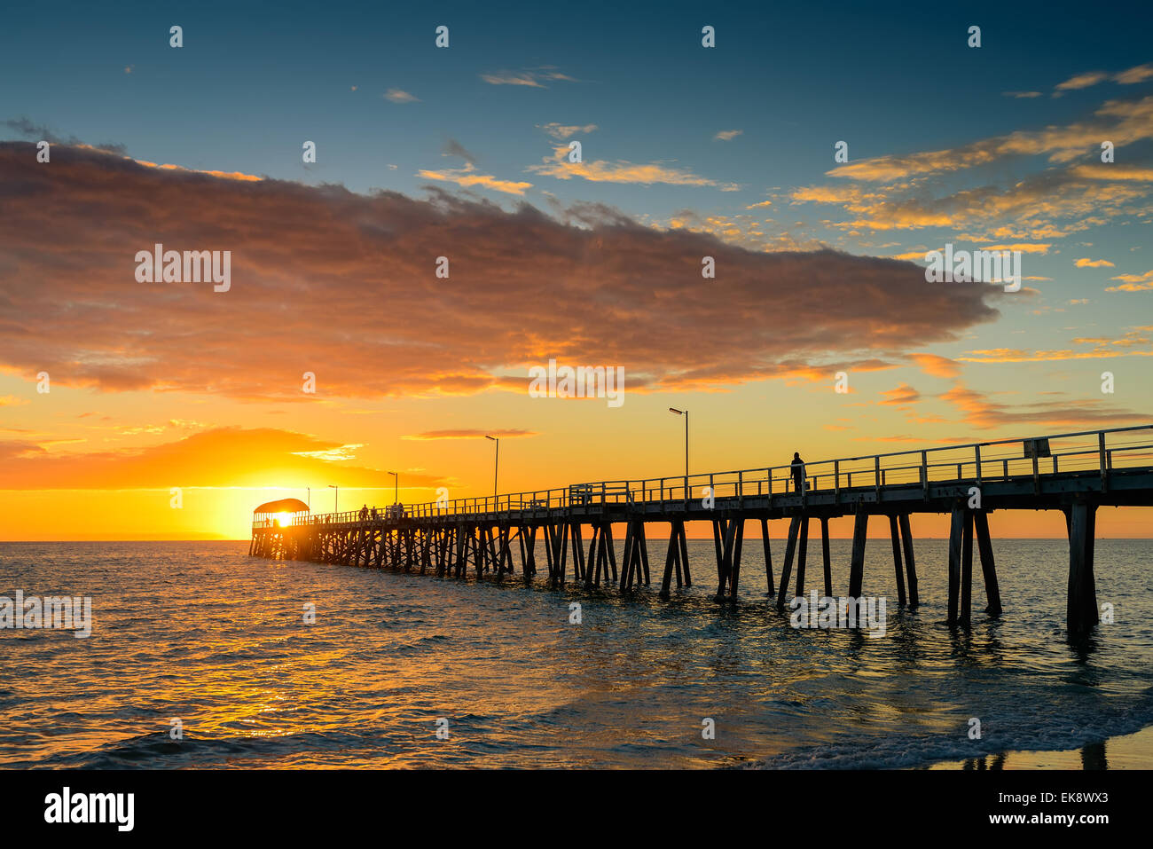 Silhouette of fisherman on the jetty at sunset Stock Photo - Alamy