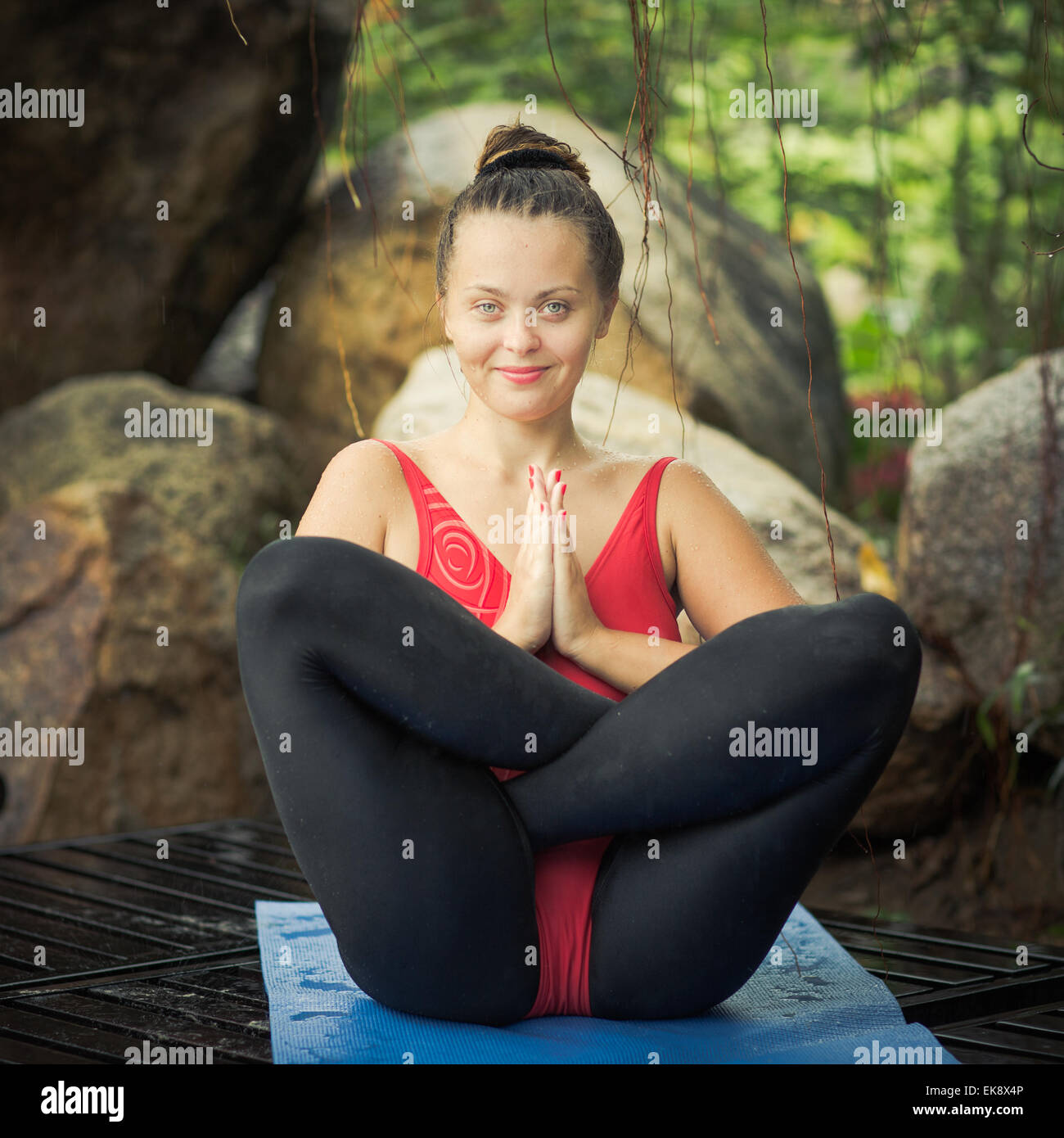Woman practicing yoga. Fetus Pose. Garbhasana Stock Photo - Alamy