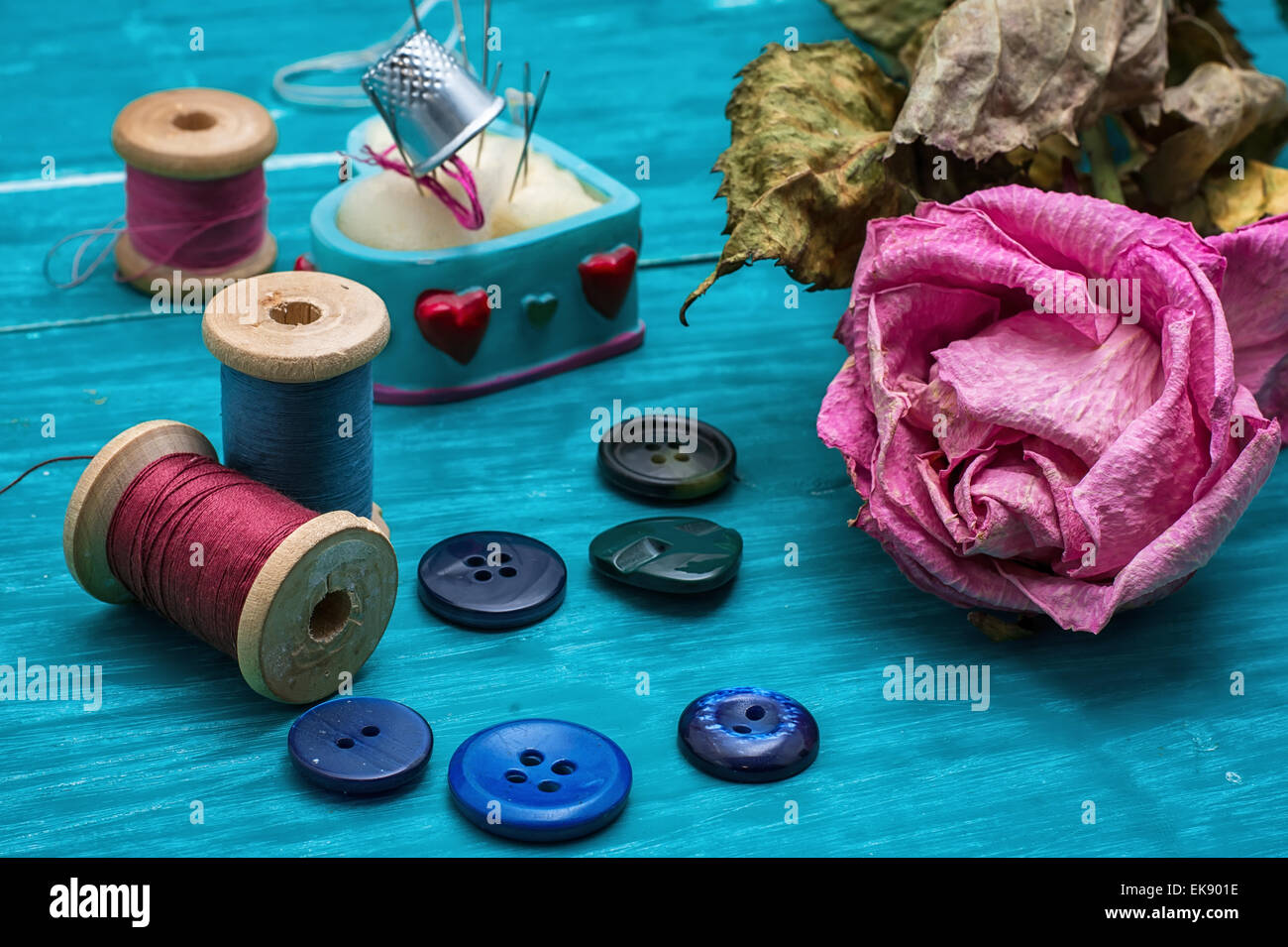 thread buttons for crafts on turquoise wooden background.Selective ...