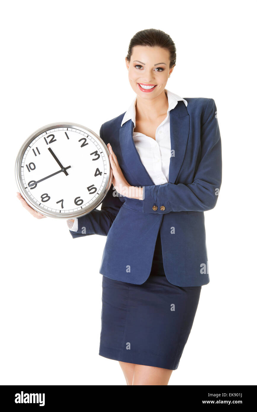 Happy young business woman holding office clock Stock Photo - Alamy