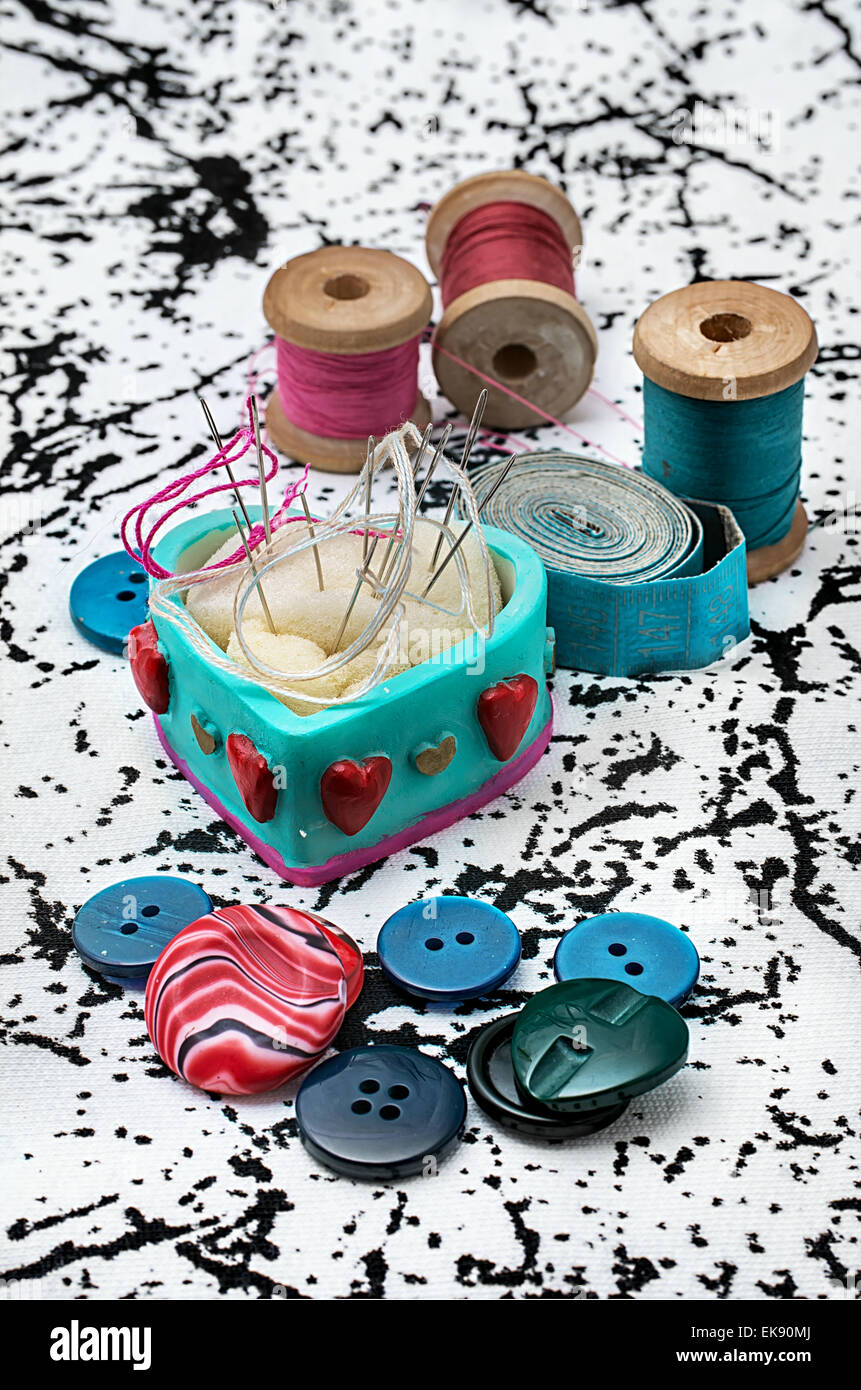 thread and buttons against the background of their white textile with ...