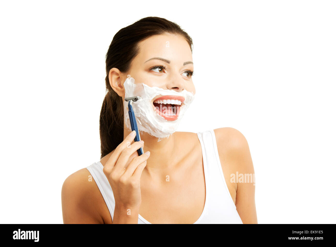 Beautiful young woman shaving her face Stock Photo - Alamy