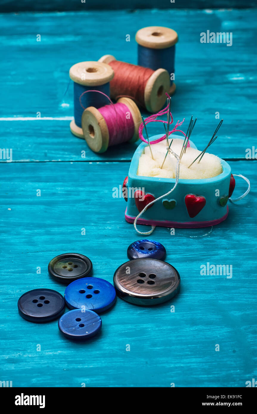 thread buttons for crafts on turquoise wooden background.Selective ...