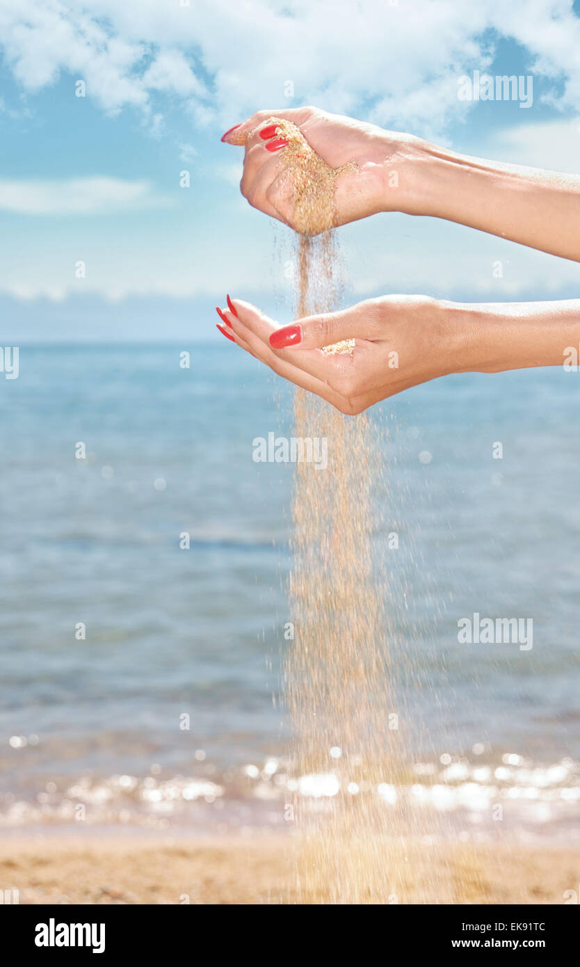 Hands and sand on the beach Stock Photo - Alamy