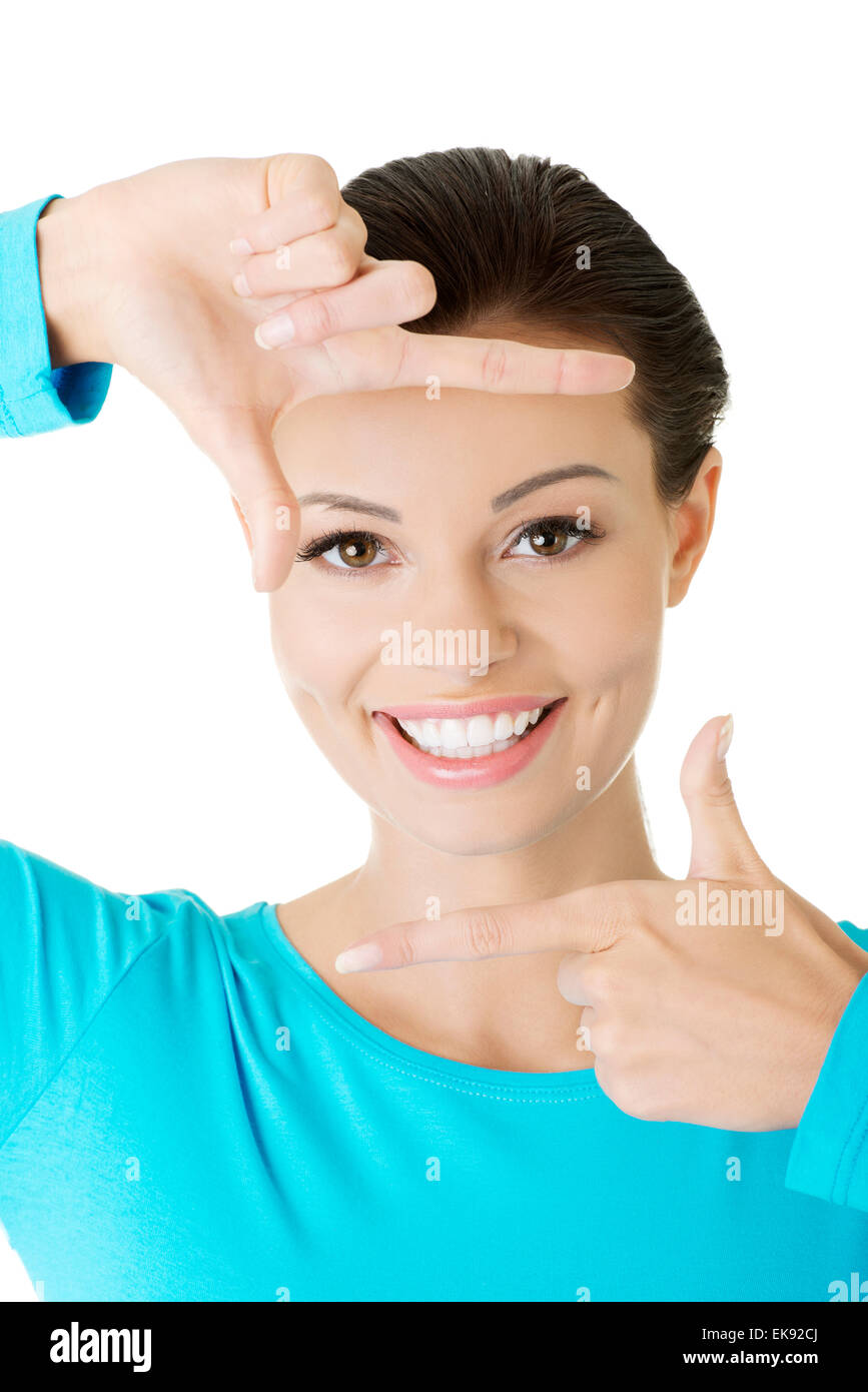 Smiling woman is showing frame by hands Stock Photo - Alamy