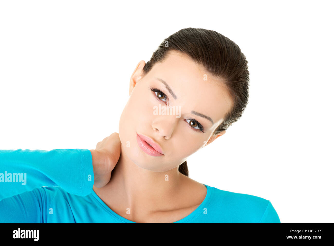 Young woman holding hand on her neck Stock Photo - Alamy