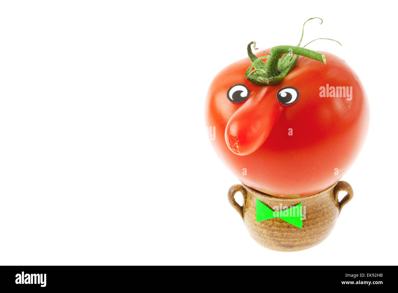 tomato with a nose lying in a small jug isolated on white Stock Photo ...